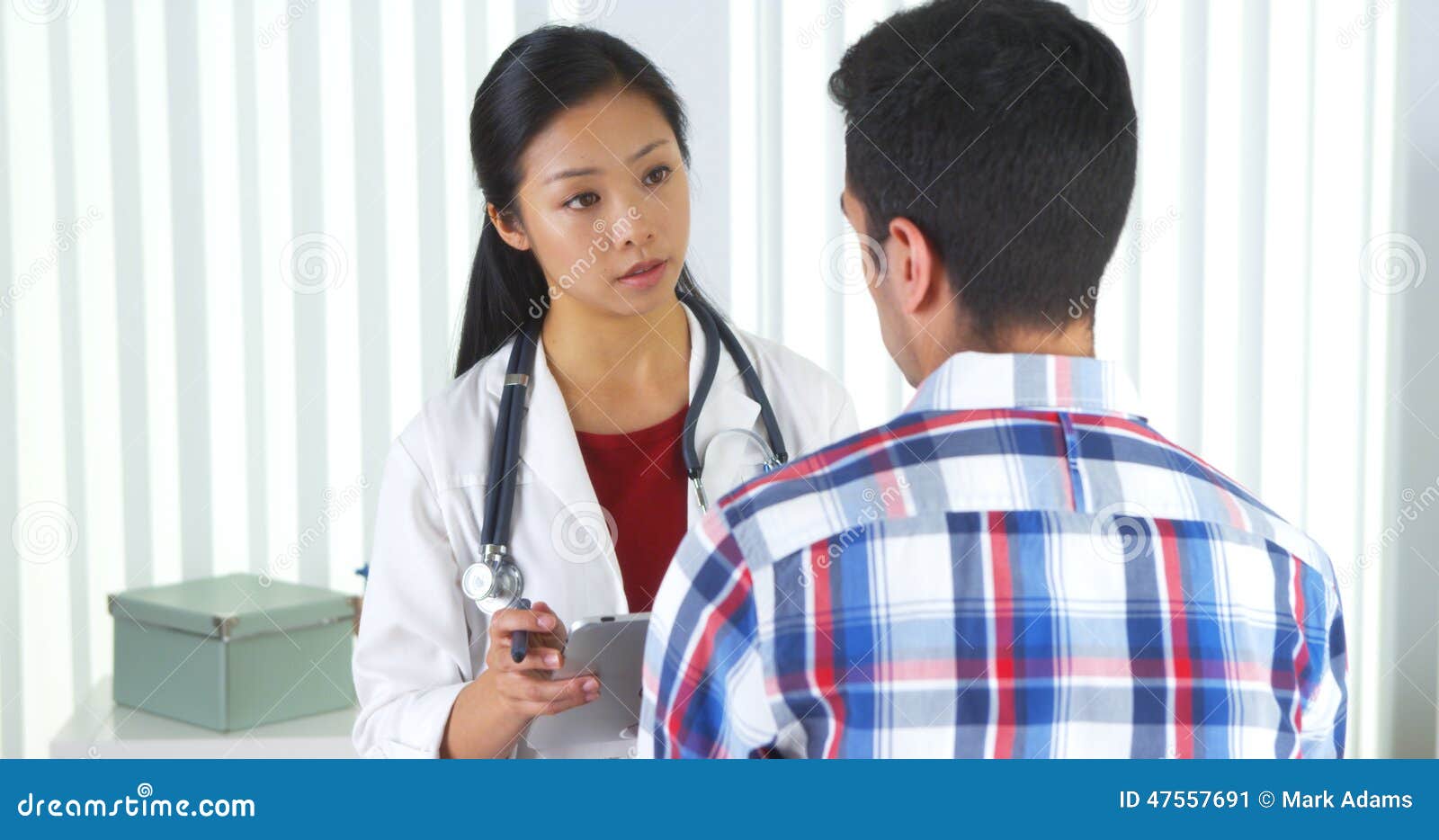 Asian Doctor Asking Patient Questions and Taking Notes Stock Image ...