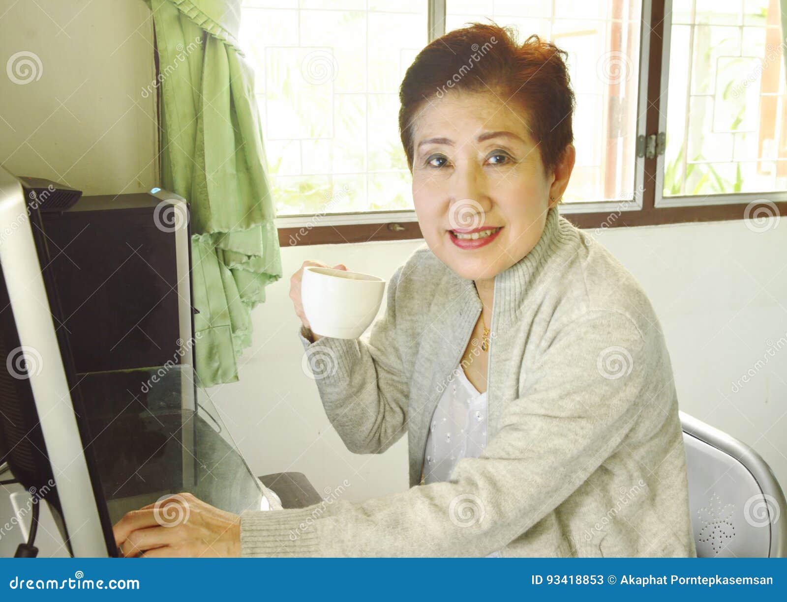 Asian Elder Woman Enjoy Her Coffee while Working with Personal Computer ...