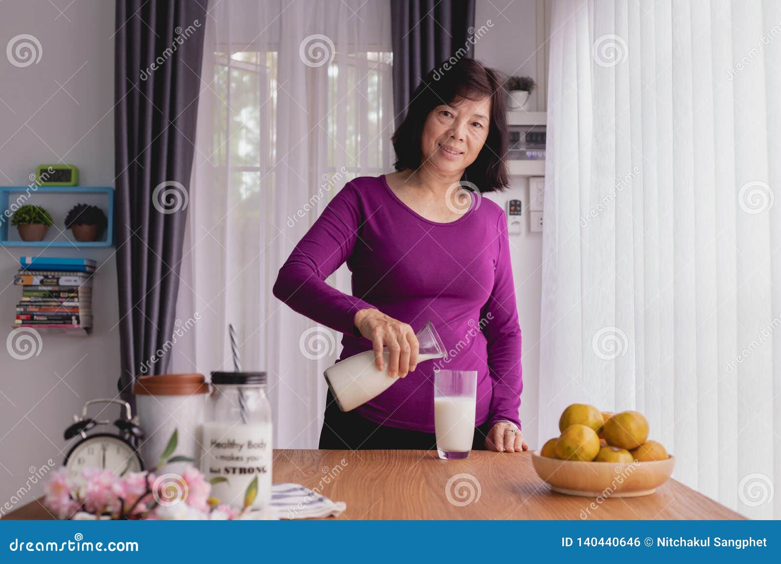 Asian Elderly Woman Pouring Milk on Kitchen Table. Breakfast Table ...