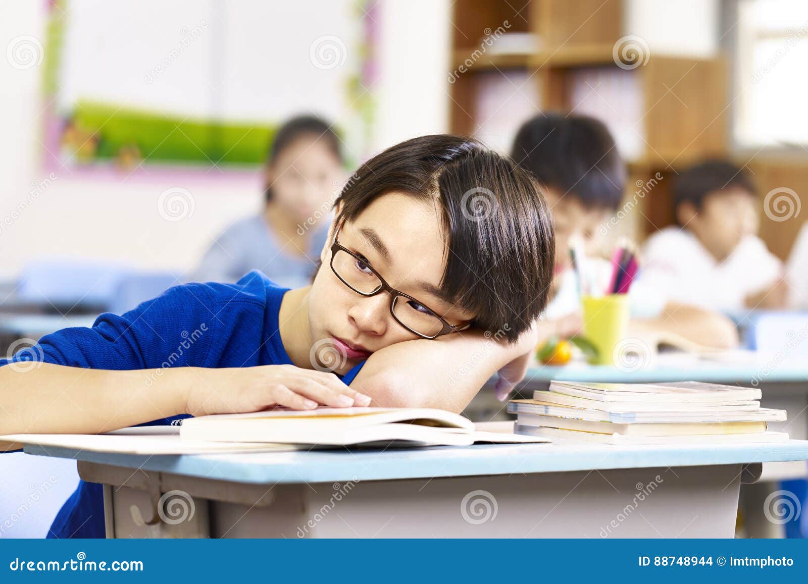 Asian Elementary School Boy Thinking in Classroom Stock Photo - Image ...