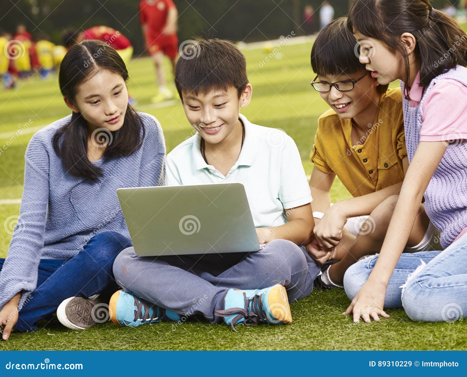 Asian Elementary School Children Using Laptop Outdoors Stock Image ...