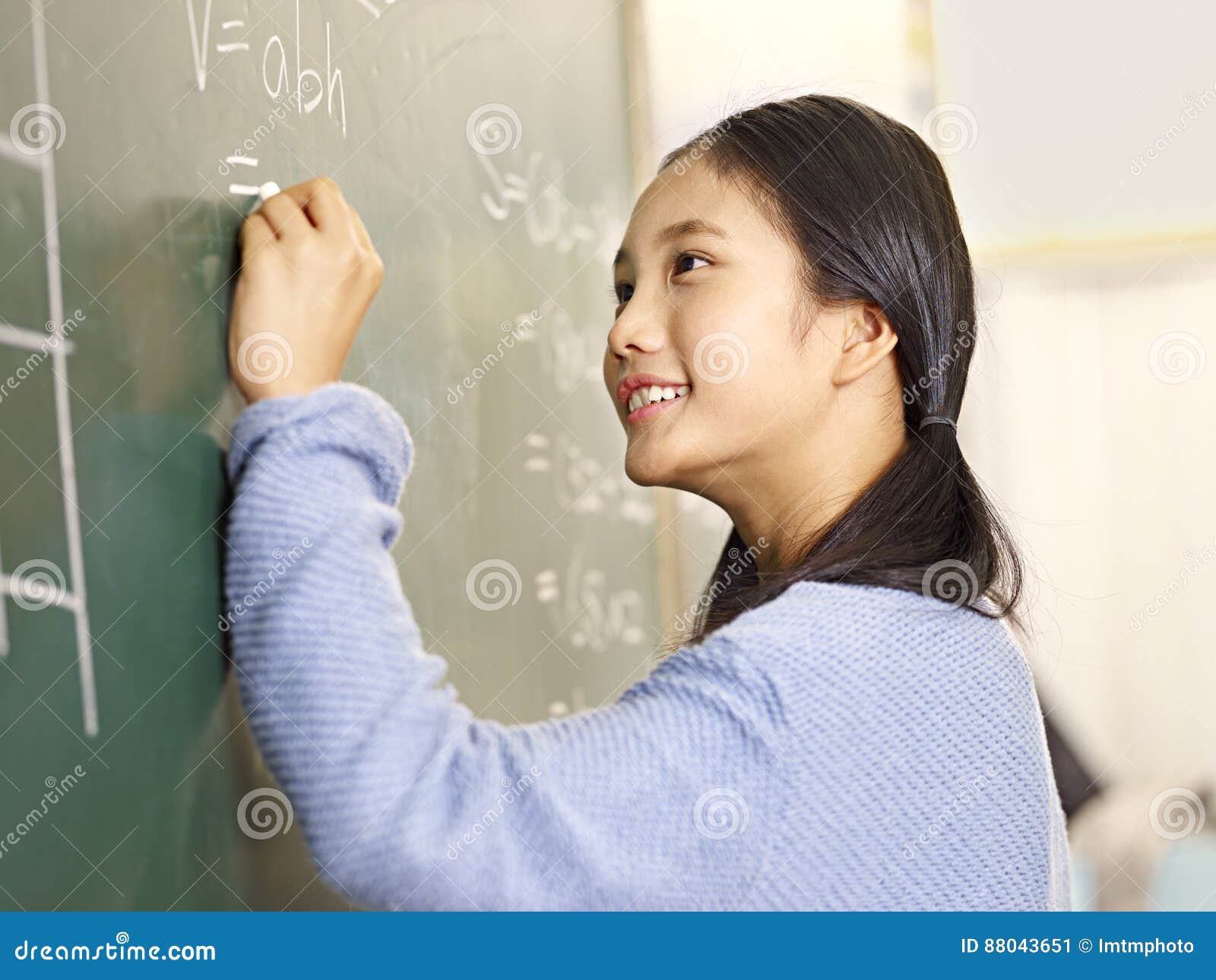 Asian Elementary School Student Solving a Math Problem Stock Image ...