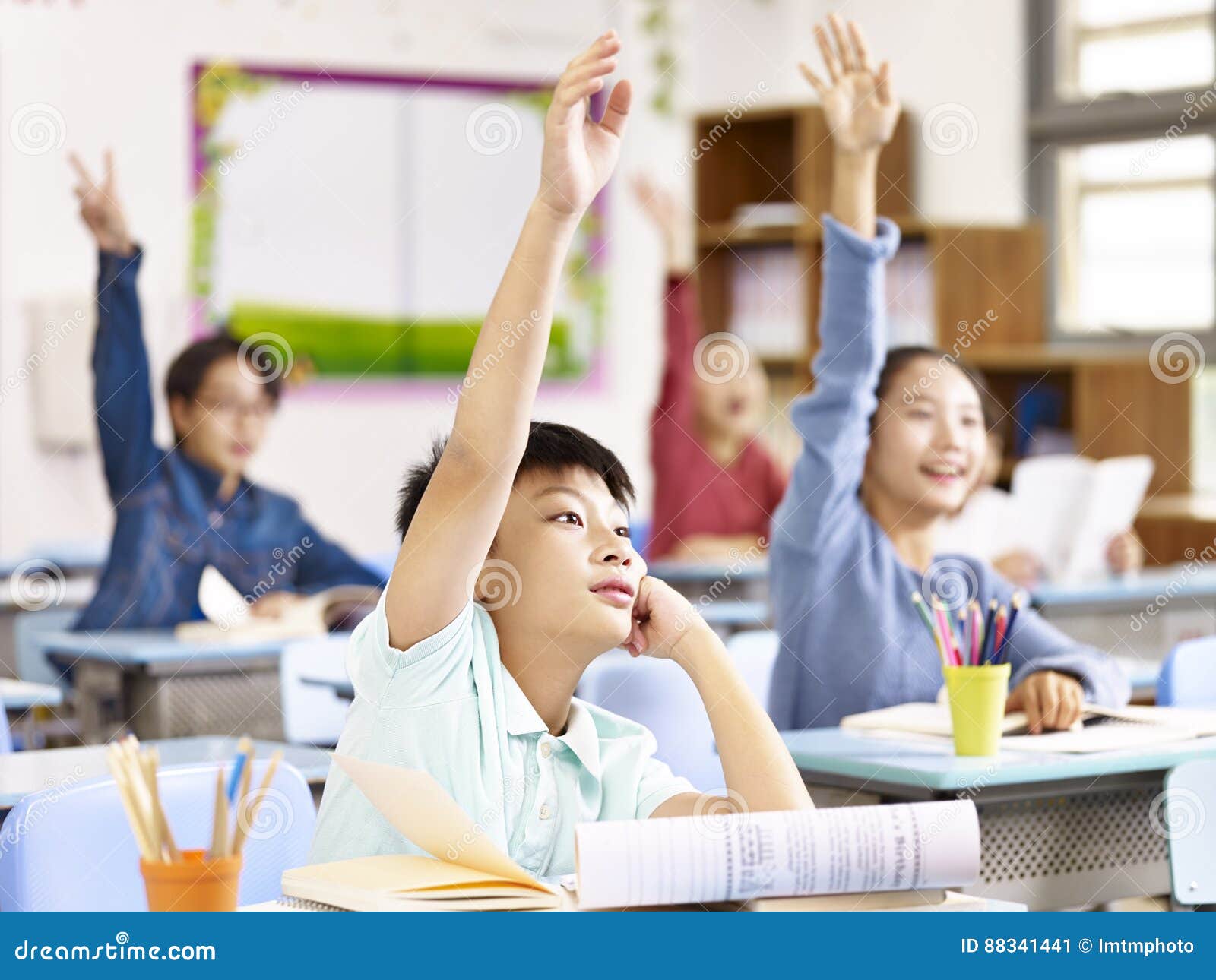 Asian Elementary School Students Raising Hands in Class Stock Image ...