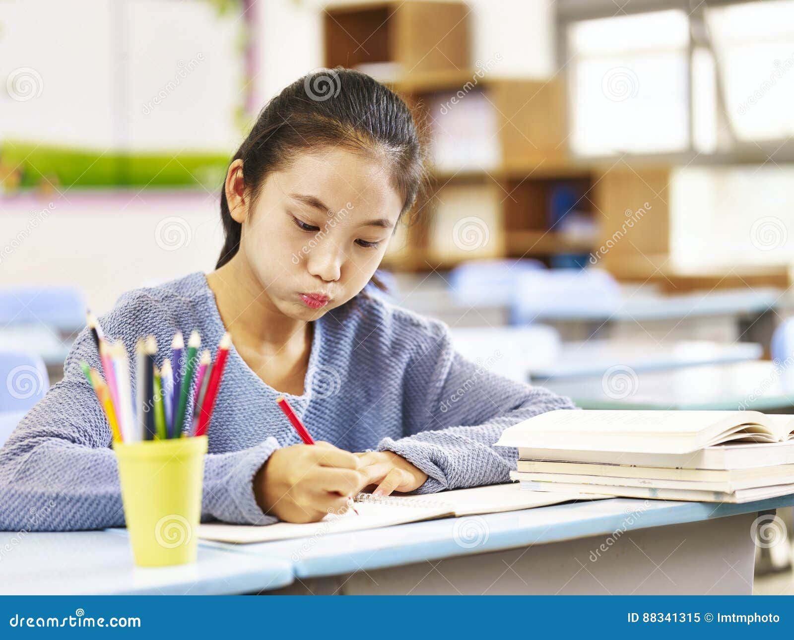Asian Elementary Schoolgirl Doing Homework in Classroom Stock Image ...