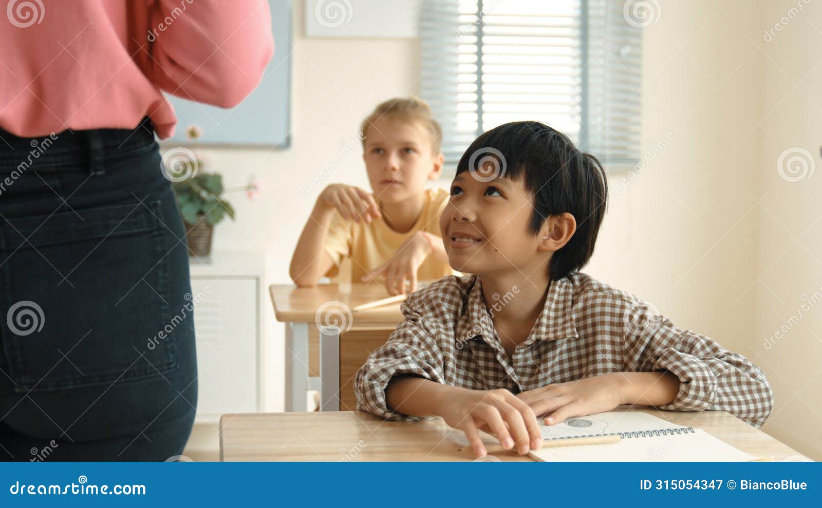 Asian Elementary Student Looking at Teacher while Attend in Classroom ...