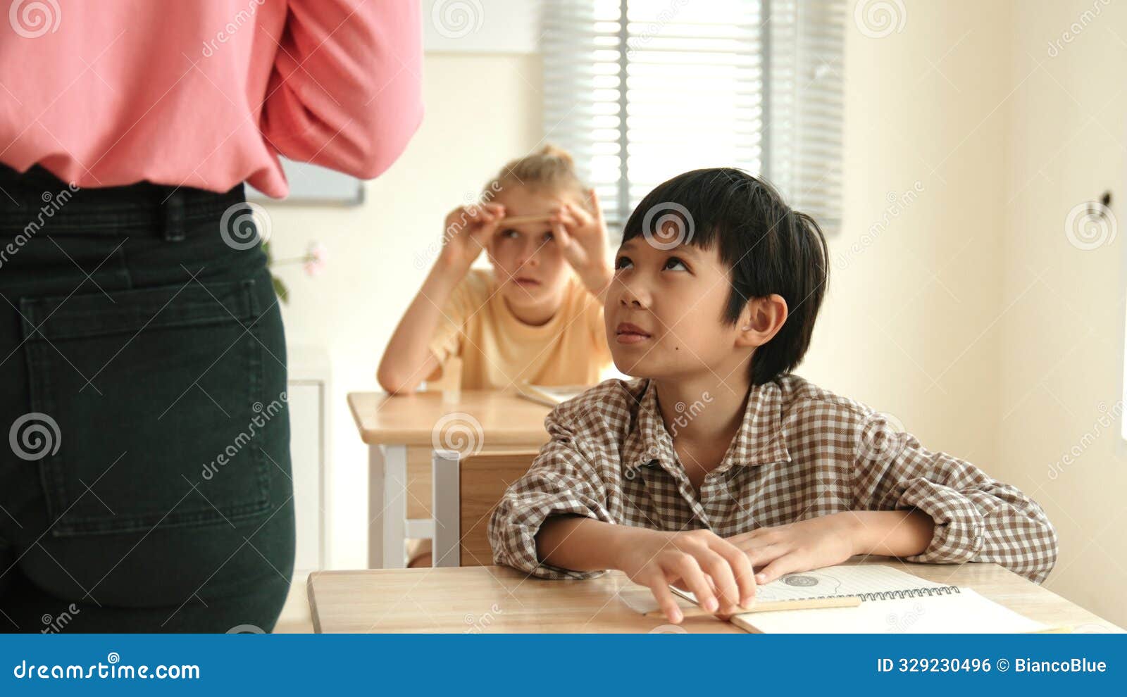 Asian Elementary Student Looking at Teacher while Attend in Classroom ...