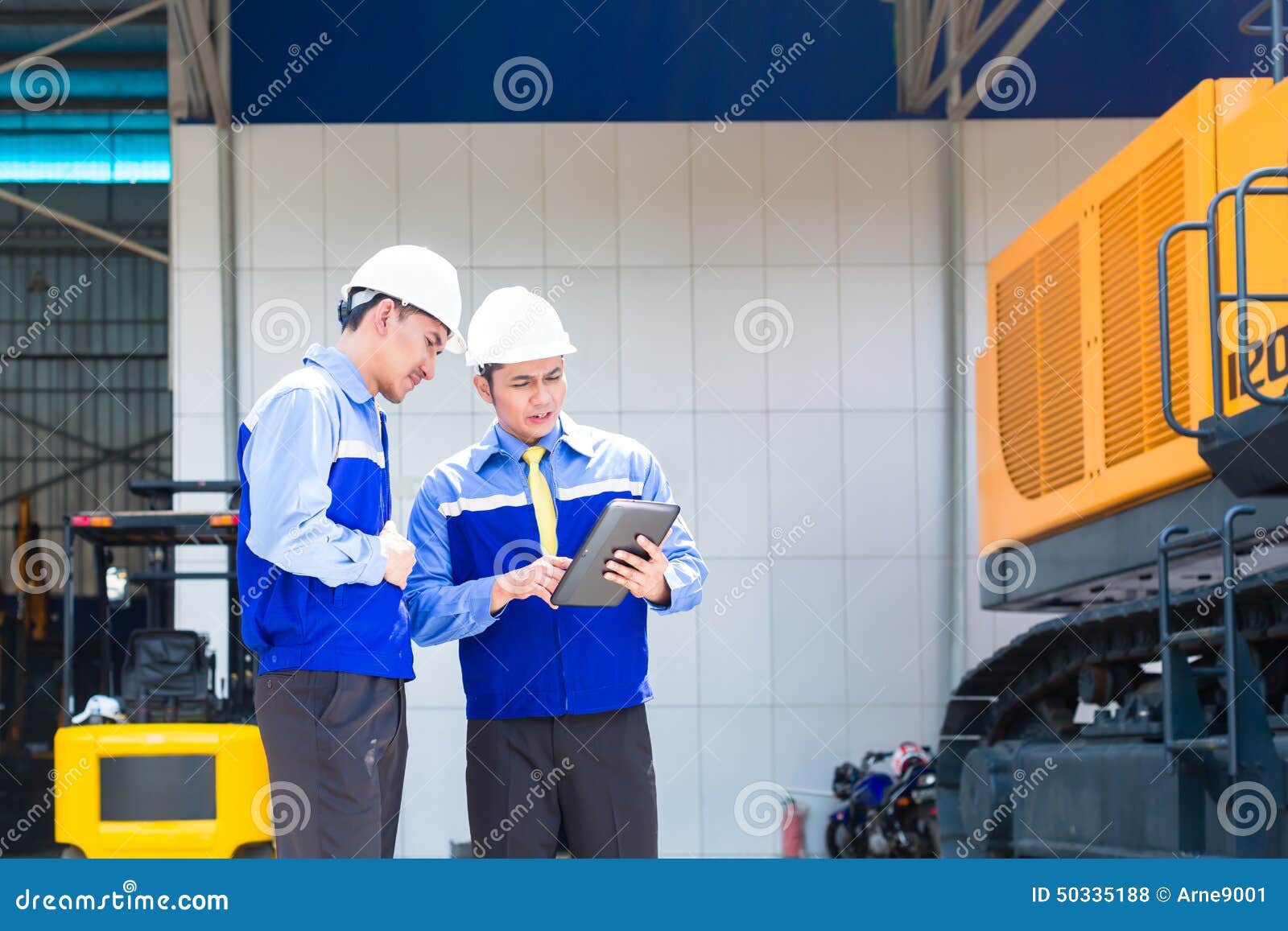 Asian Engineer Discussing Plans on Construction Site Stock Photo ...