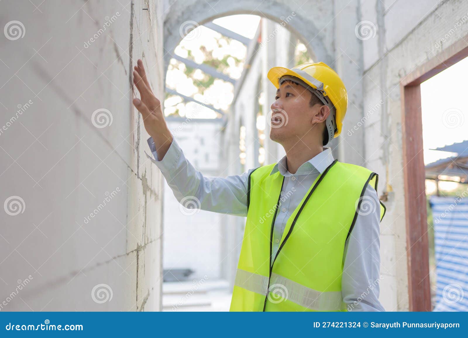 Asian Engineer in Uniform at Construction Site while Checking and ...