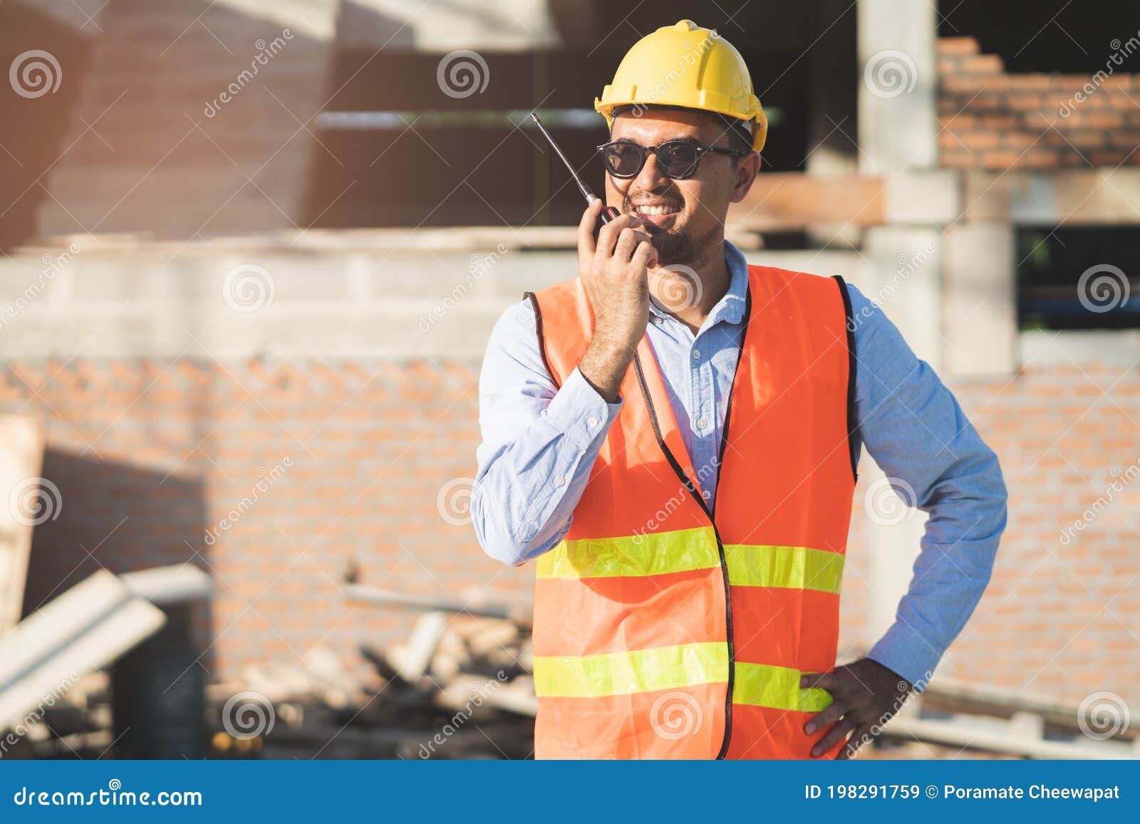 Asian Engineer Using Radio To Command To Labour Team in Site ...