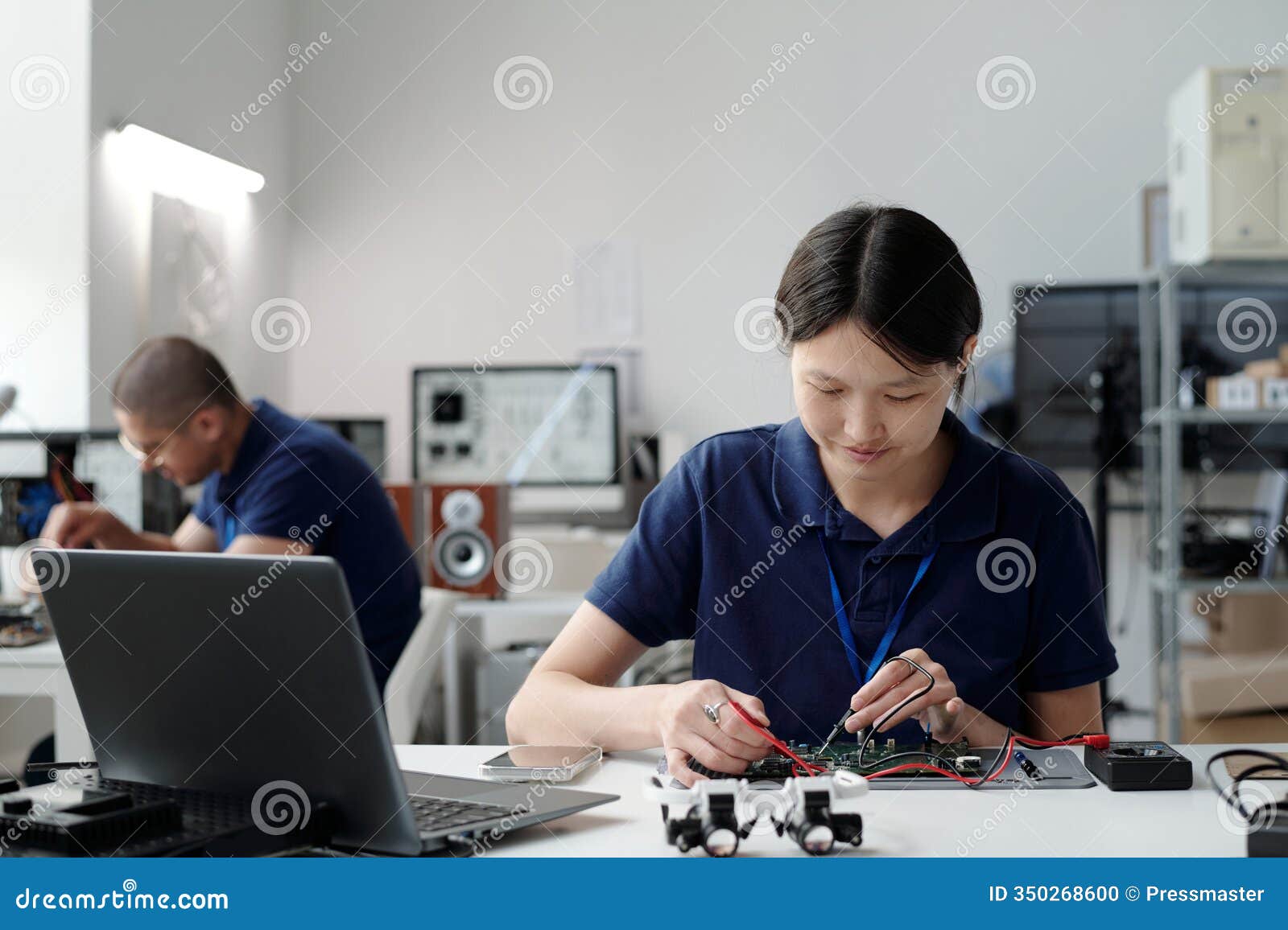 Asian Engineer Working on Electronic Device in Modern Lab Stock Photo ...