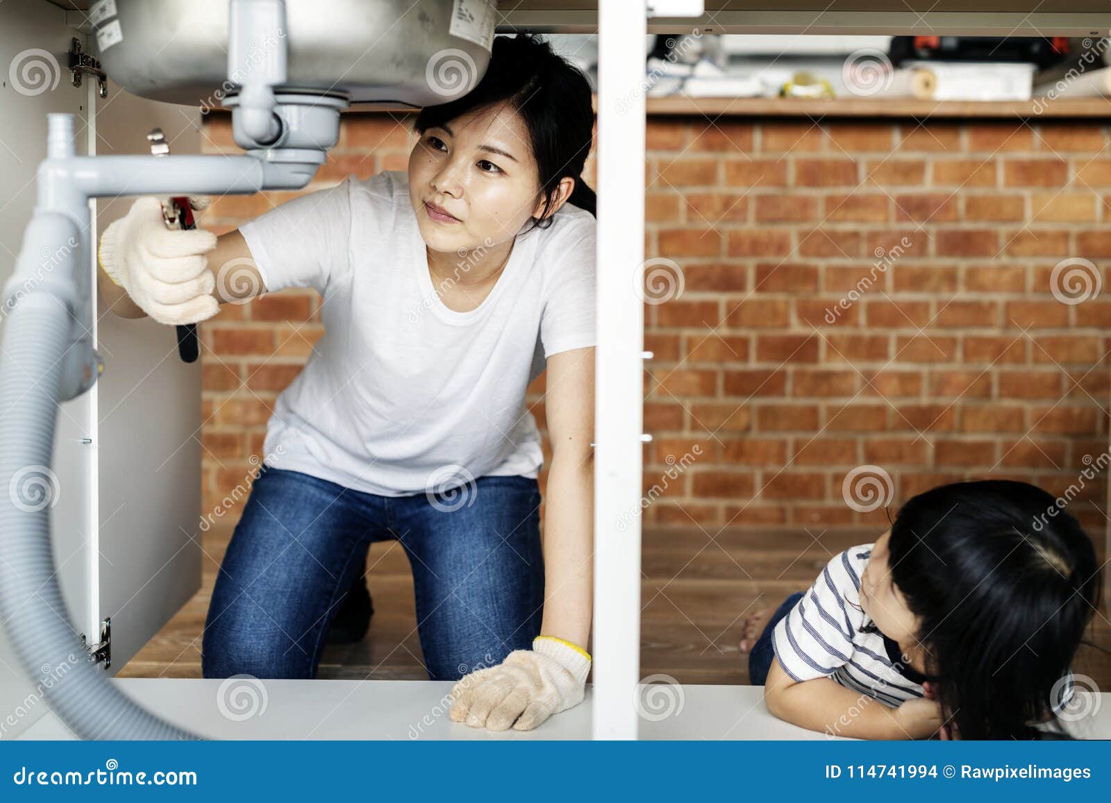 Asian Family Fixing Kitchen Sink Stock Photo - Image of installing ...