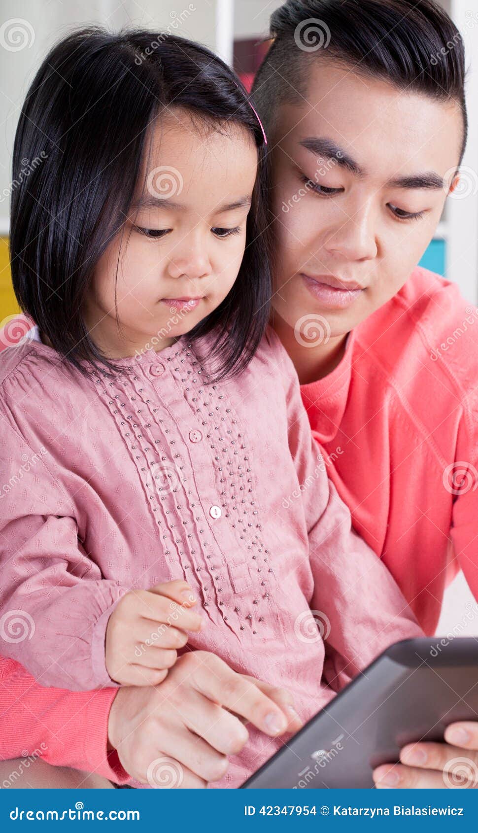 Asian family using tablet stock photo. Image of play - 42347954