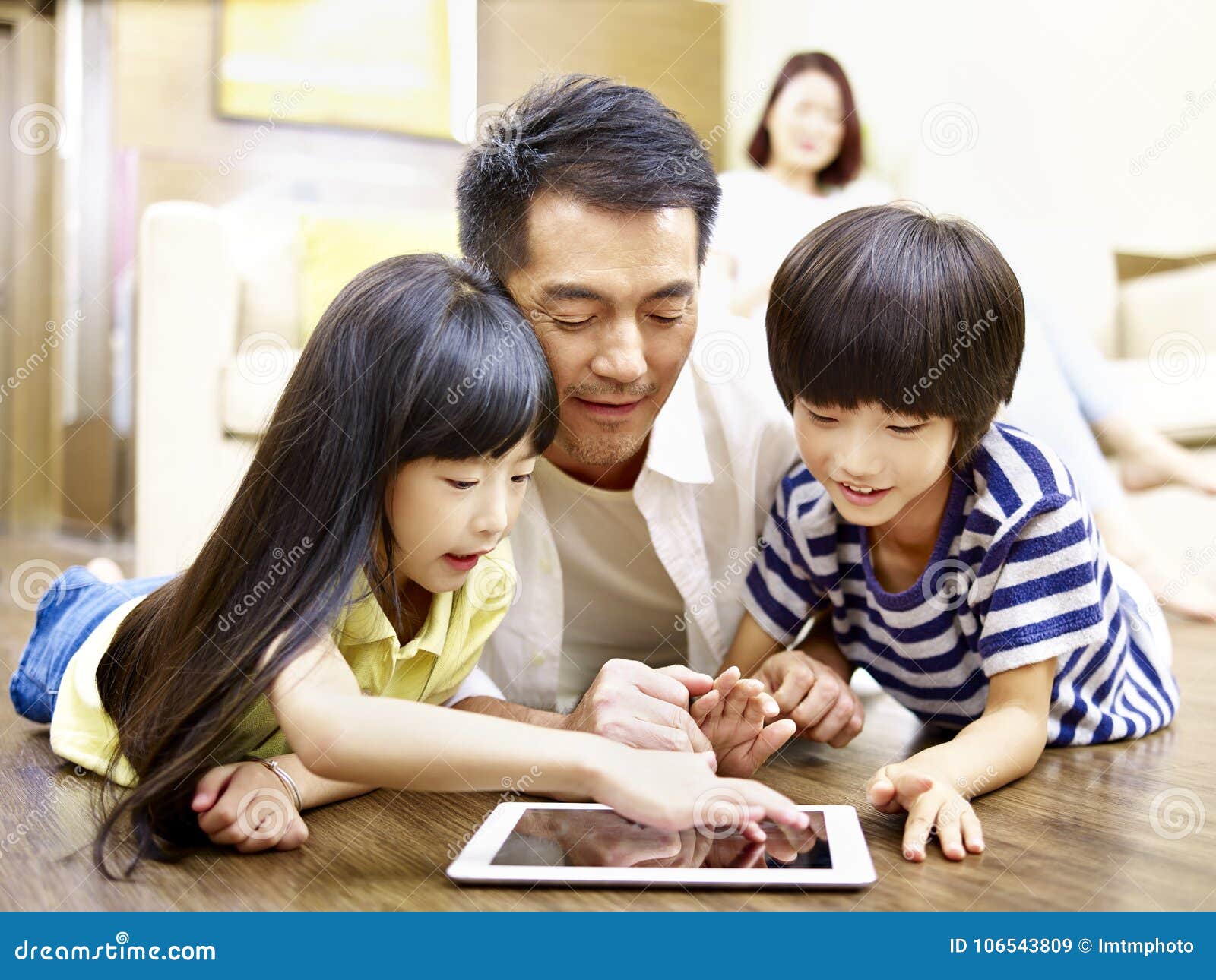 Asian Father and Two Children Using Digital Tablet Together Stock Image ...