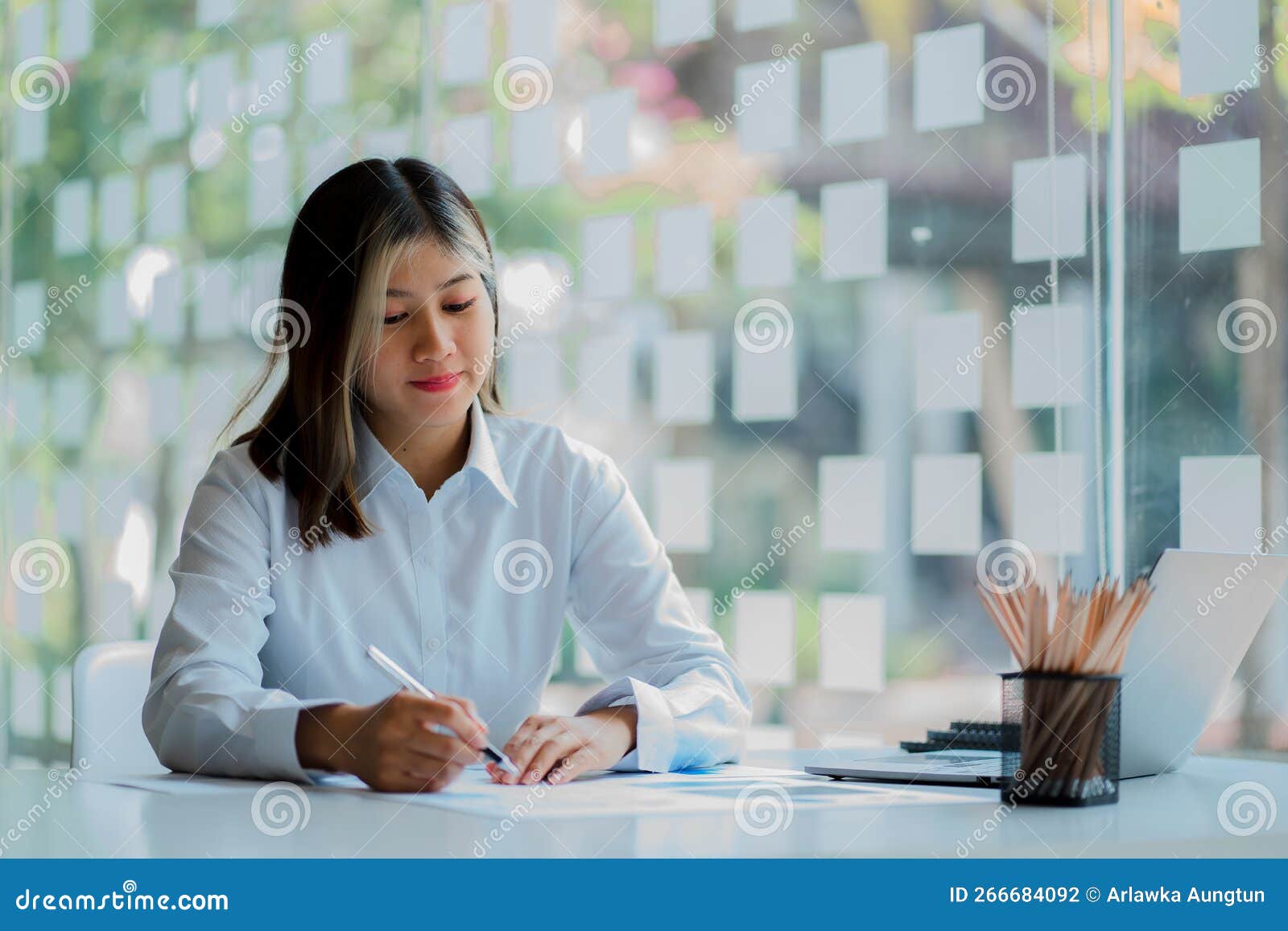 Asian Female Accountant Doing Calculations Analyzing Reports Pointing ...
