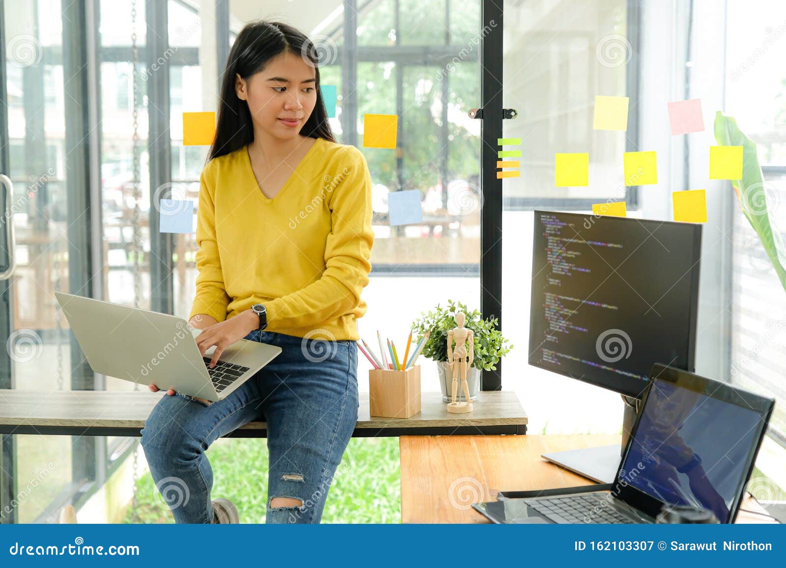 Asian Female Programmer for Yellow Shirt Sit on the Shelf and Place ...