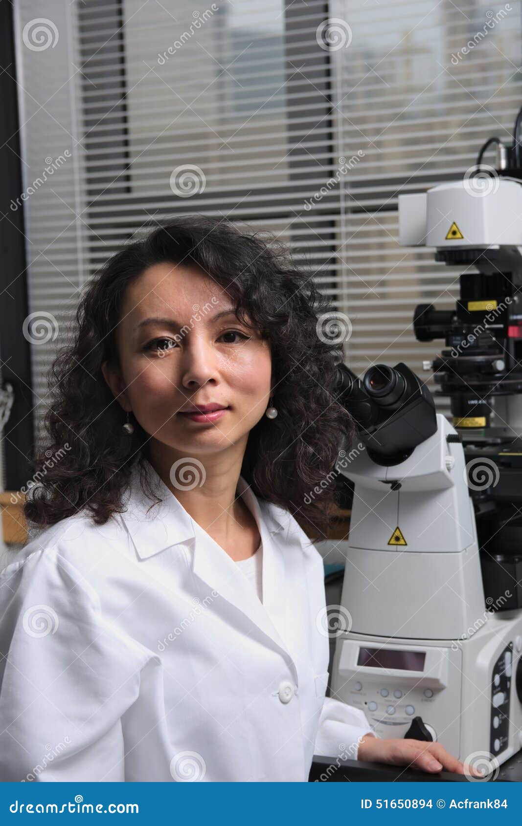Asian Female Scientist Sitting at Microscope Stock Photo - Image of ...