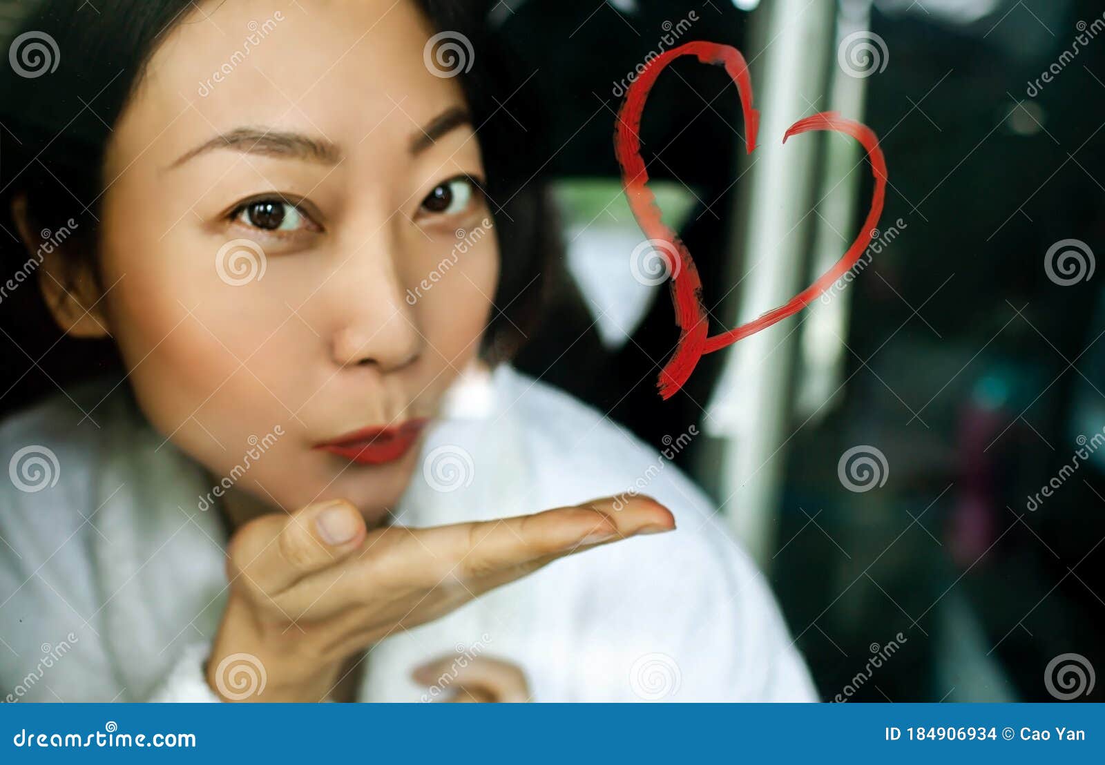 Asian Female In White Bathrobe Drawing Heart With Crimson Lipstick