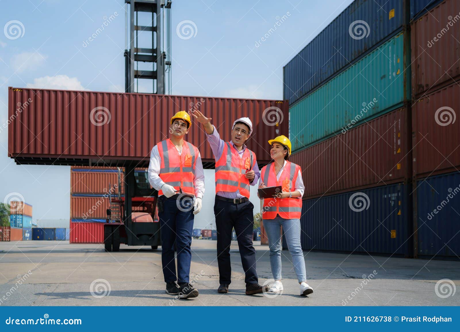 Asian Foreman Walking and Explaining the Various Operations in the ...