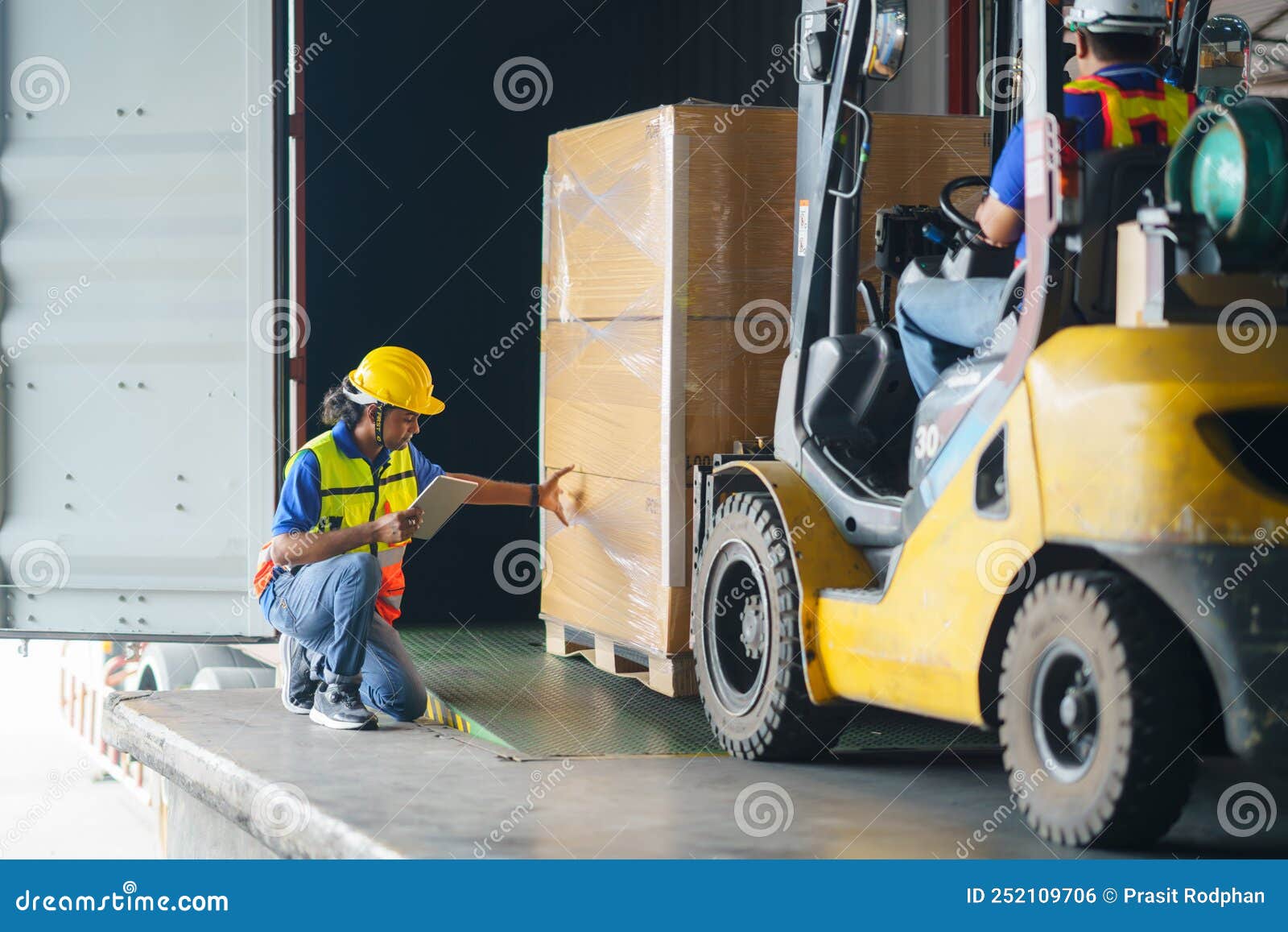 Asian Forklift Driver Loading A Shipping Cargo Container With A Full ...
