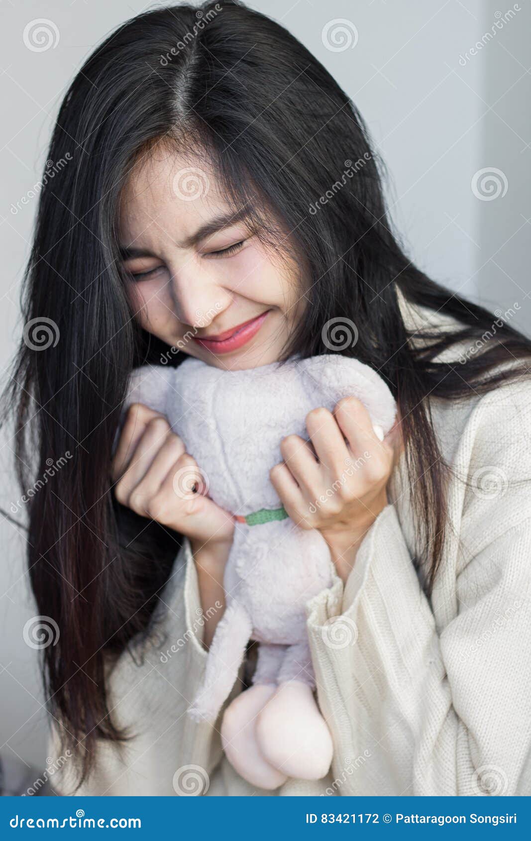 Asian girl hug her doll. stock photo. Image of asian - 83421172