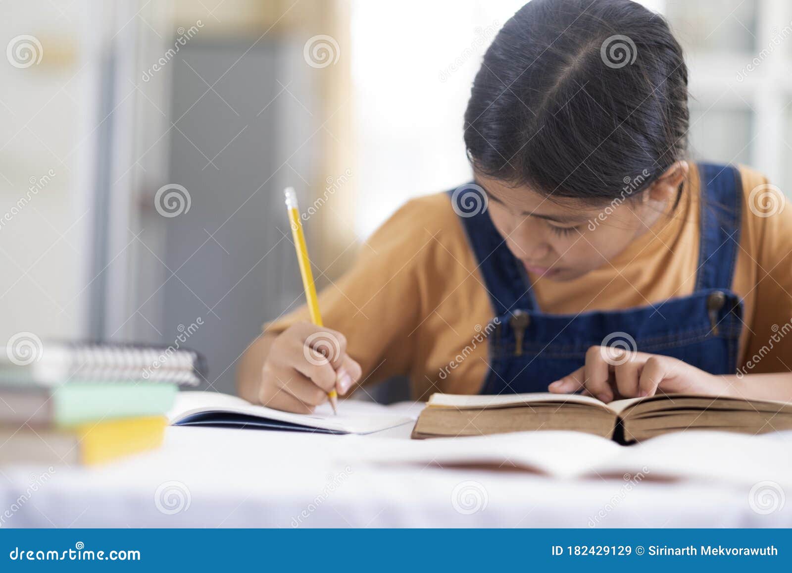Asian Girl Reading and Doing Homework at Her Home Stock Image - Image ...