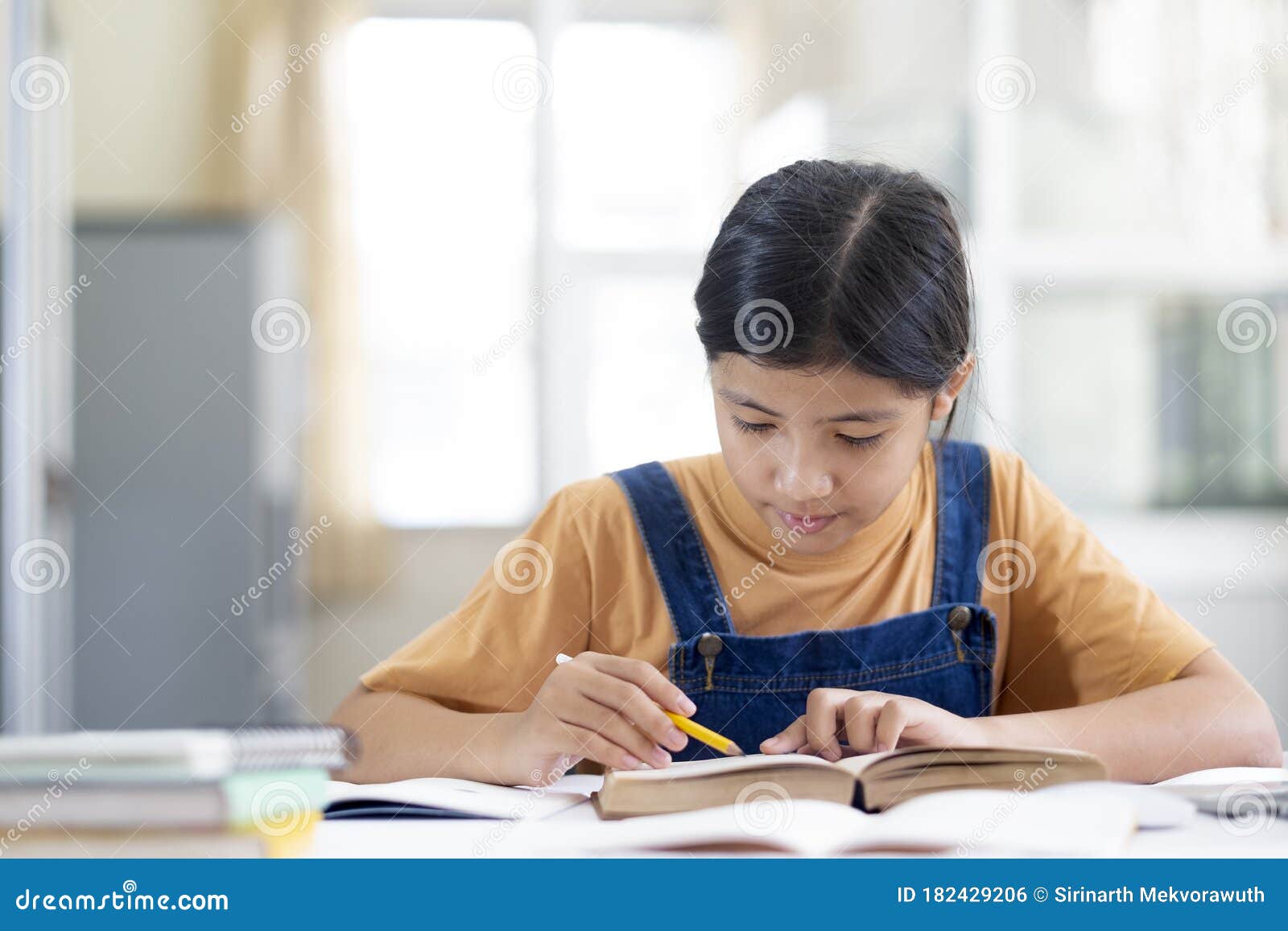 Asian Girl Reading and Doing Homework at Her Home Stock Photo - Image ...