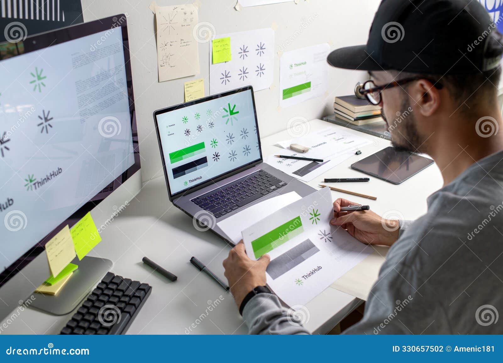 Graphic Designer Making Notes on Logo Designs, Designing Logos, and ...