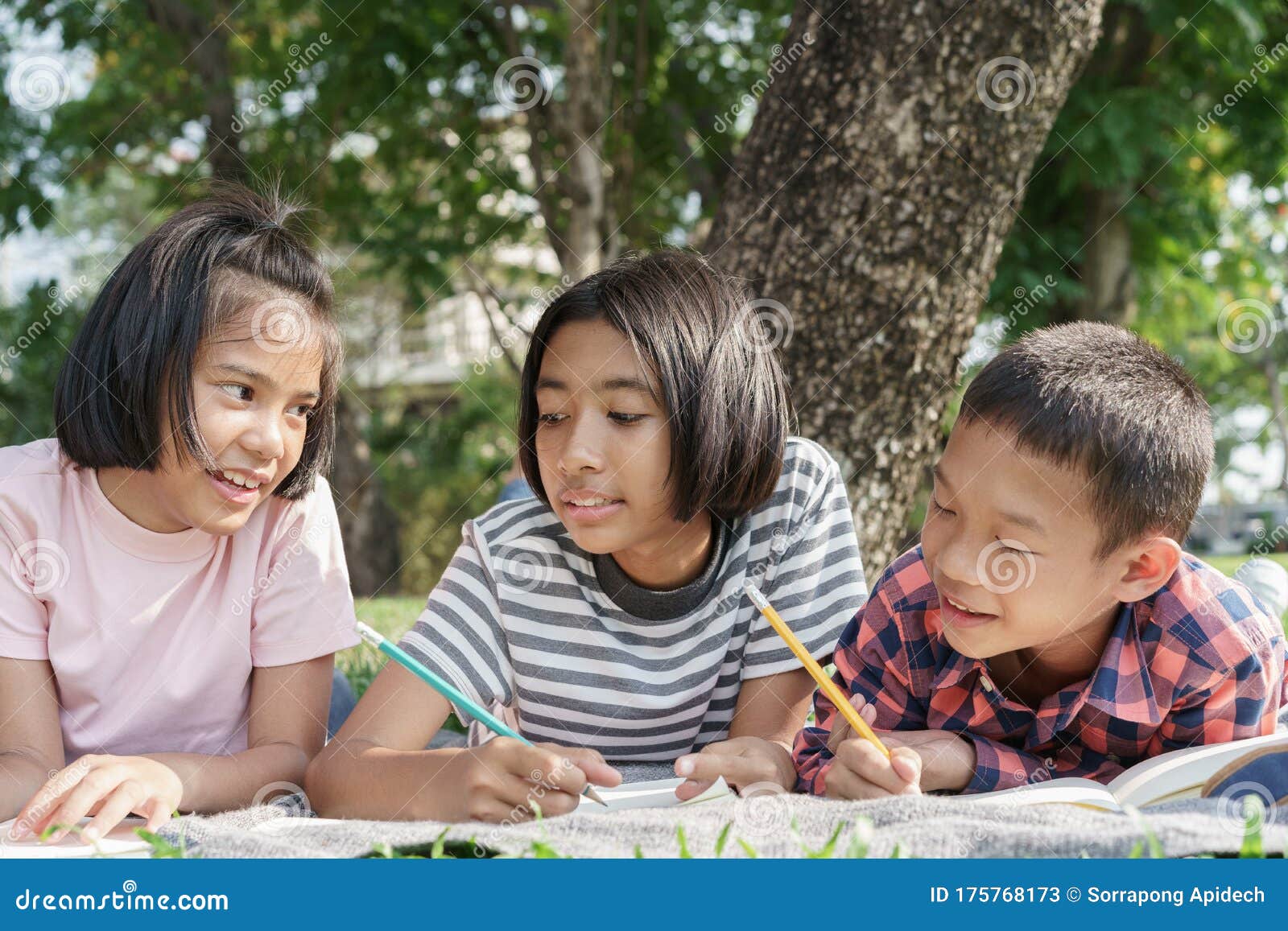 Asian Group Elementary School Children Write a Notebook with a Pencil ...