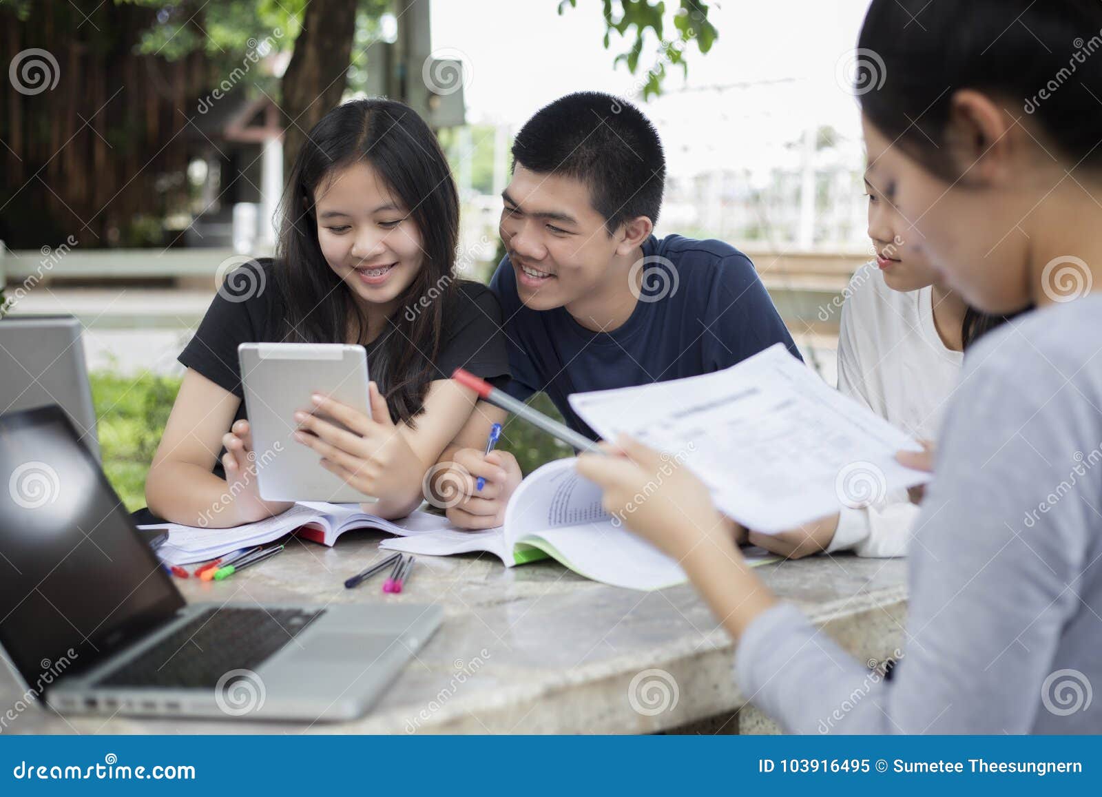 Asian Group of Students Using Tablet and Notebook Sharing with T Stock ...