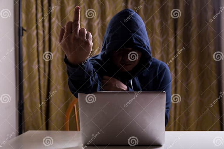 Asian Hacker Show Middle Finger while Hacking Computer Network Stock ...