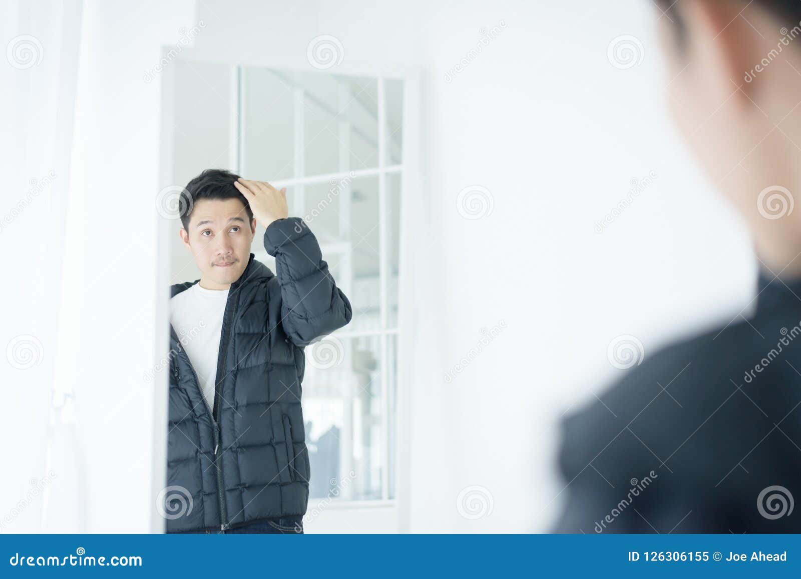 Asian Handsome Man Looking at Himself in Mirror Indoors Stock Image ... Asian Handsome Man Looking at Himself in Mirror Indoors Stock Image ...