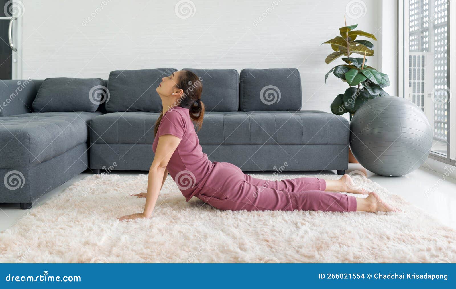 Asian Housewife Doing Cobra Pose Exercise During Home Workout Female
