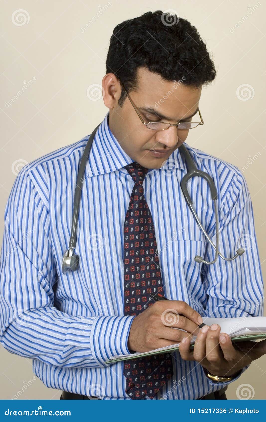 Asian Indian Doctor Writing a Report Stock Photo - Image of handsome ...