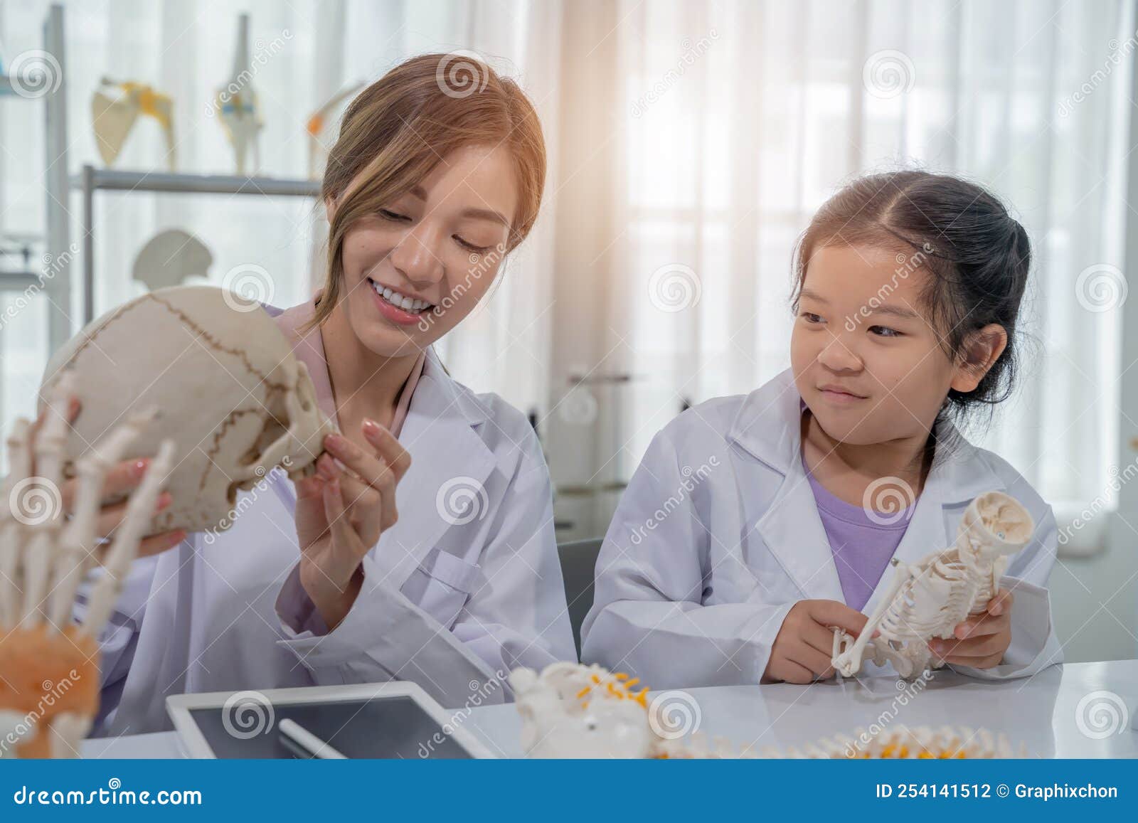 Asian Kid Learning with Doctor in the Laboratory. Physical Examination ...
