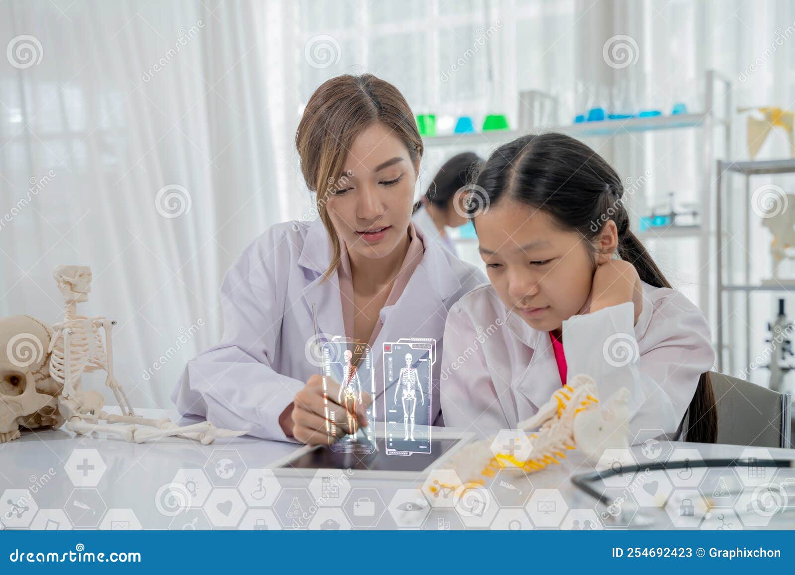 Asian Kid Learning with Doctor in the Laboratory. Physical Examination ...
