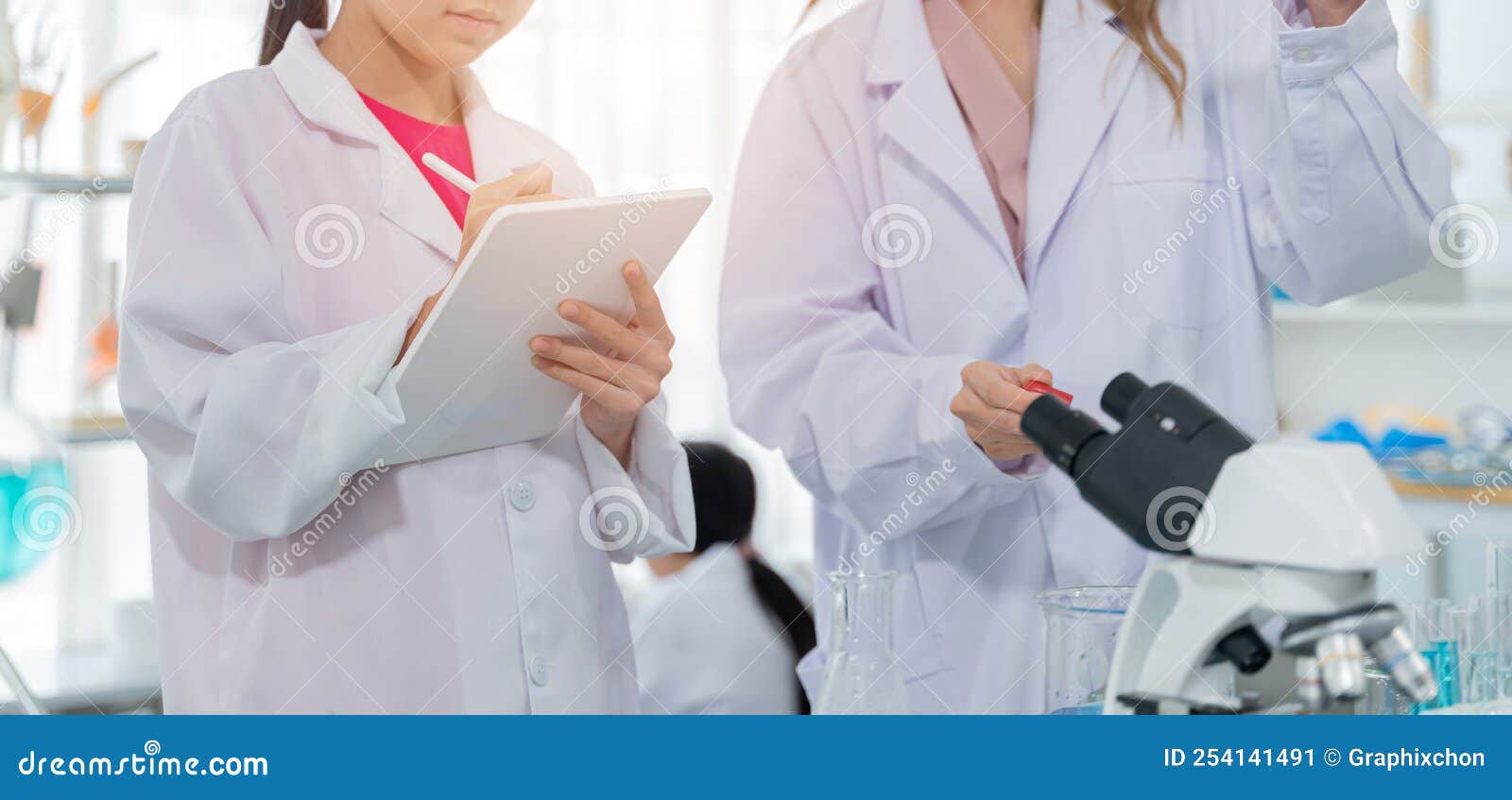 Asian Kid Learning with Scientist in the Laboratory. Physical ...