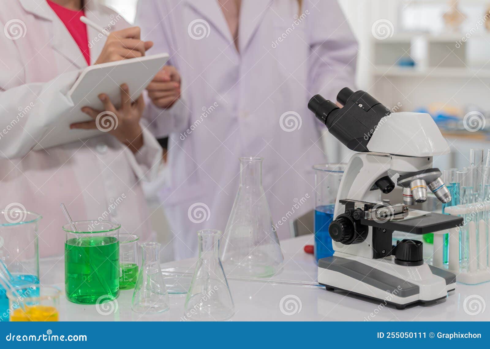 Asian Kid Learning with Scientist in the Laboratory. Physical ...
