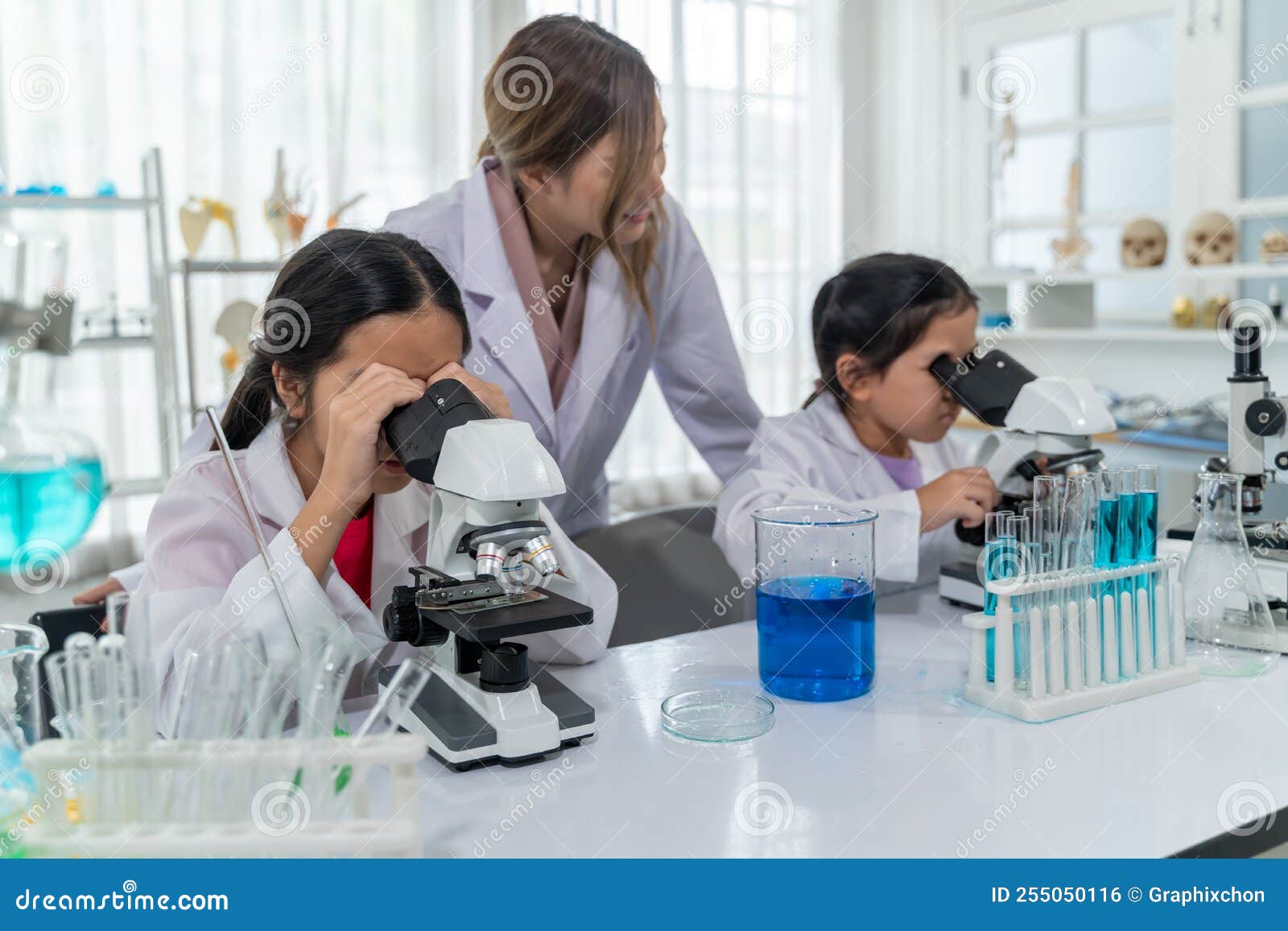 Asian Kid Learning with Scientist in the Laboratory. Physical ...