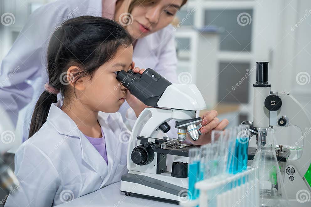 Asian Kid Learning with Scientist in the Laboratory. Physical ...