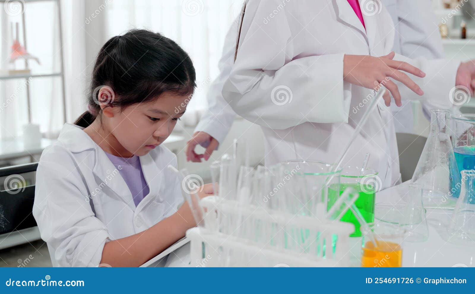 Asian Kid Learning with Scientist in the Laboratory. Physical ...