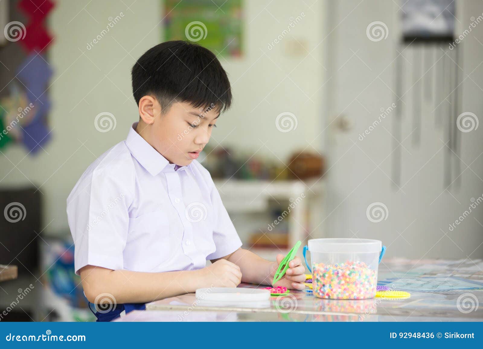 Asian Kid Looking at His Craft at Kindergarten Stock Photo - Image of ...