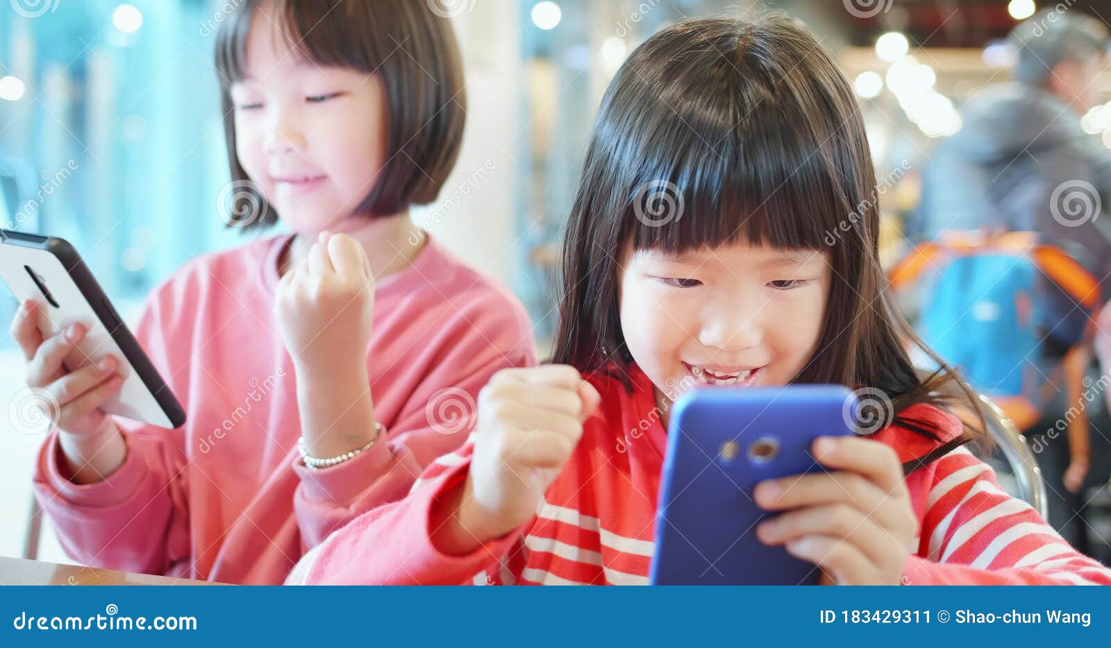 Asian kid play cell phone stock image. Image of phone - 183429311
