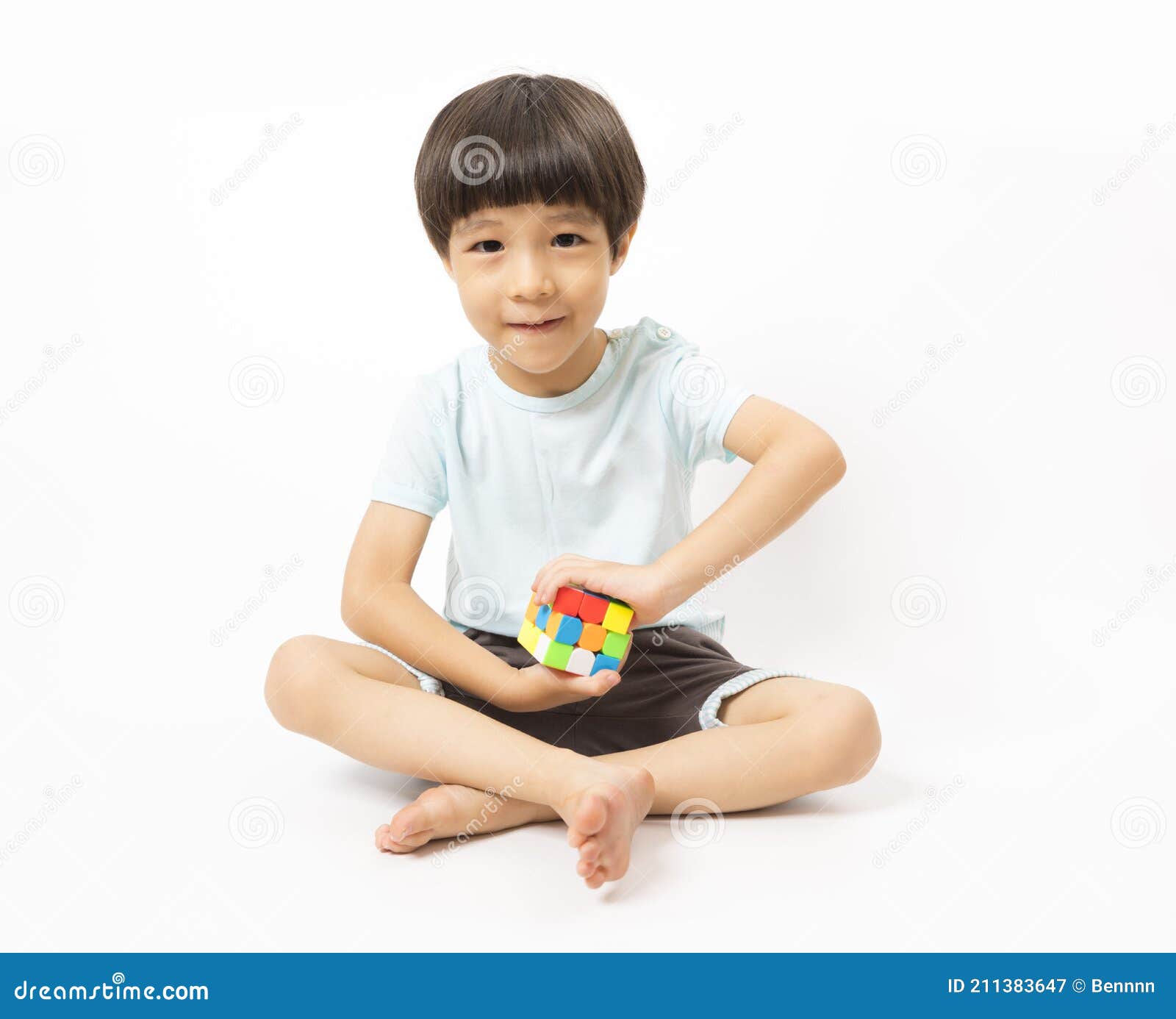 Asian Kid Play Magic Rubik Cube on White Background. Editorial ...