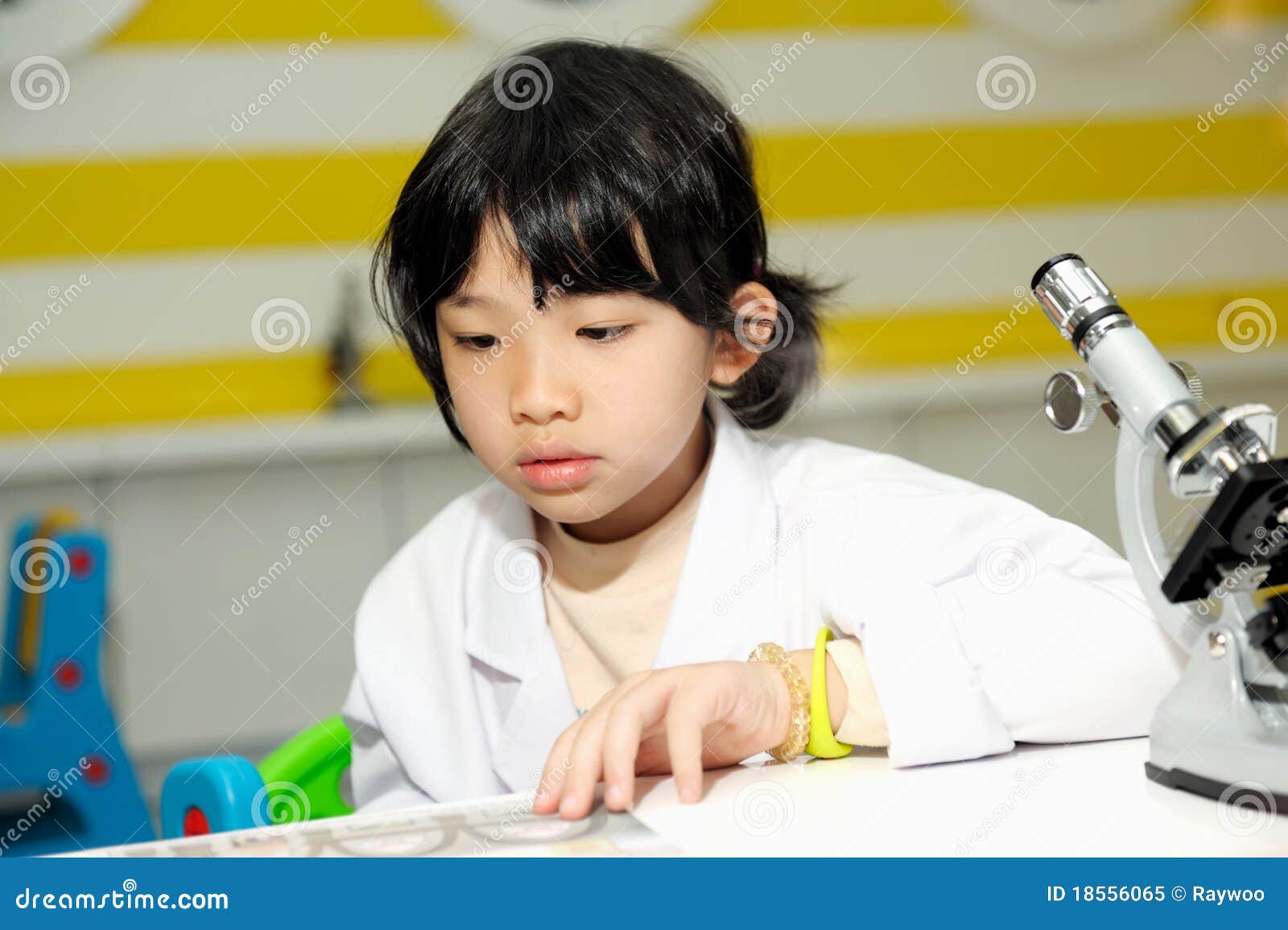 Asian Kid Sitting By Microscope Royalty-Free Stock Photo ...