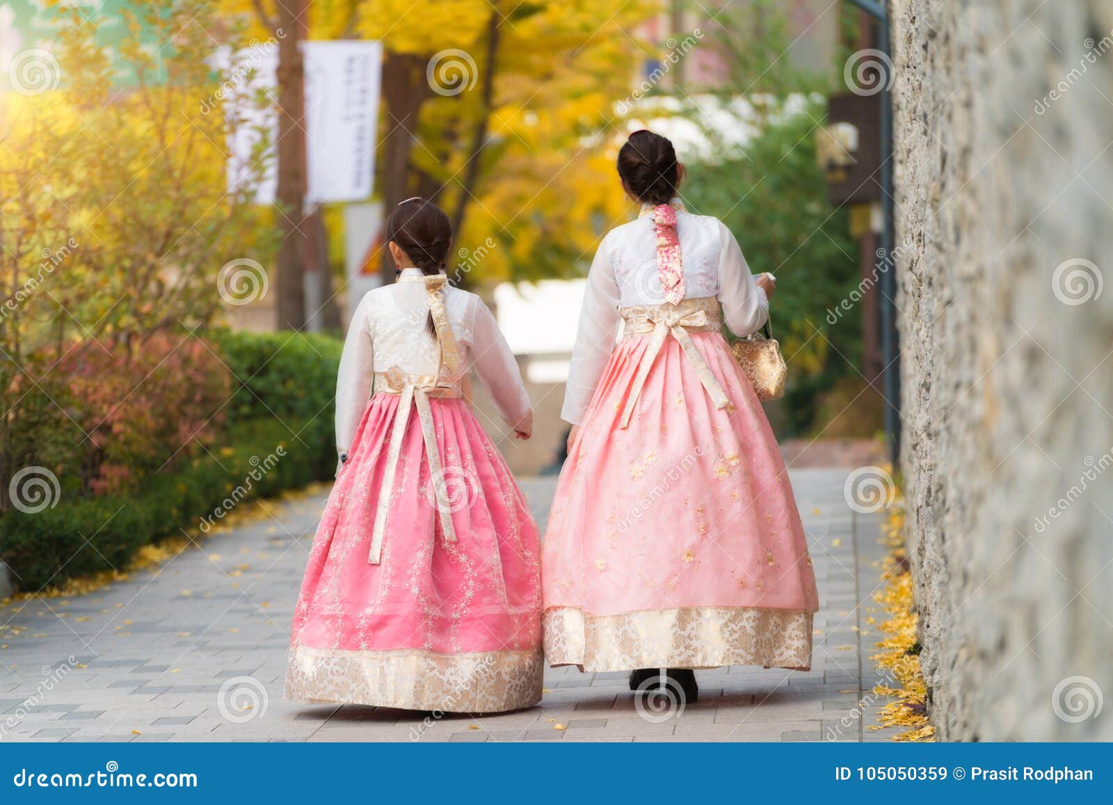 Asian Korean Woman Dressed Hanbok In Traditional Dress Walking In