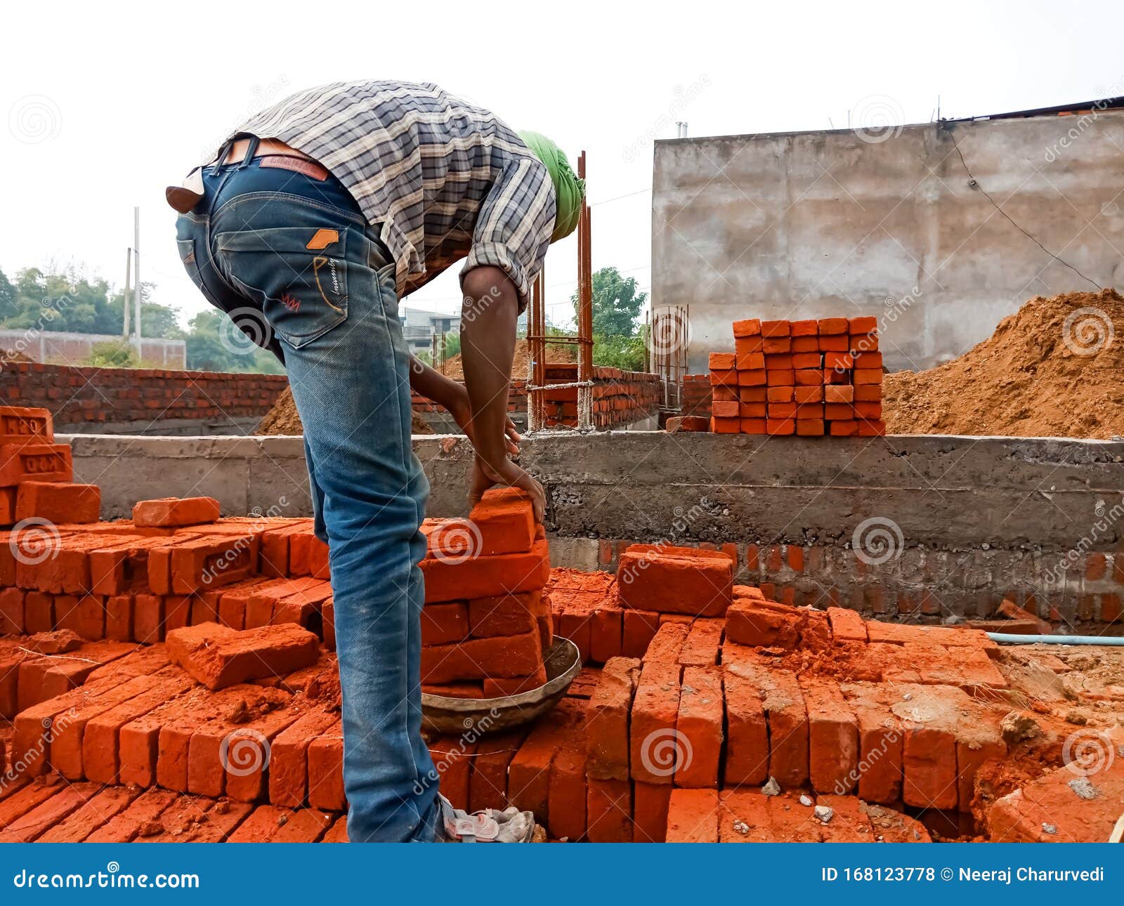 Asian Labour Arranging Bricks for Transportation at Construction Site ...