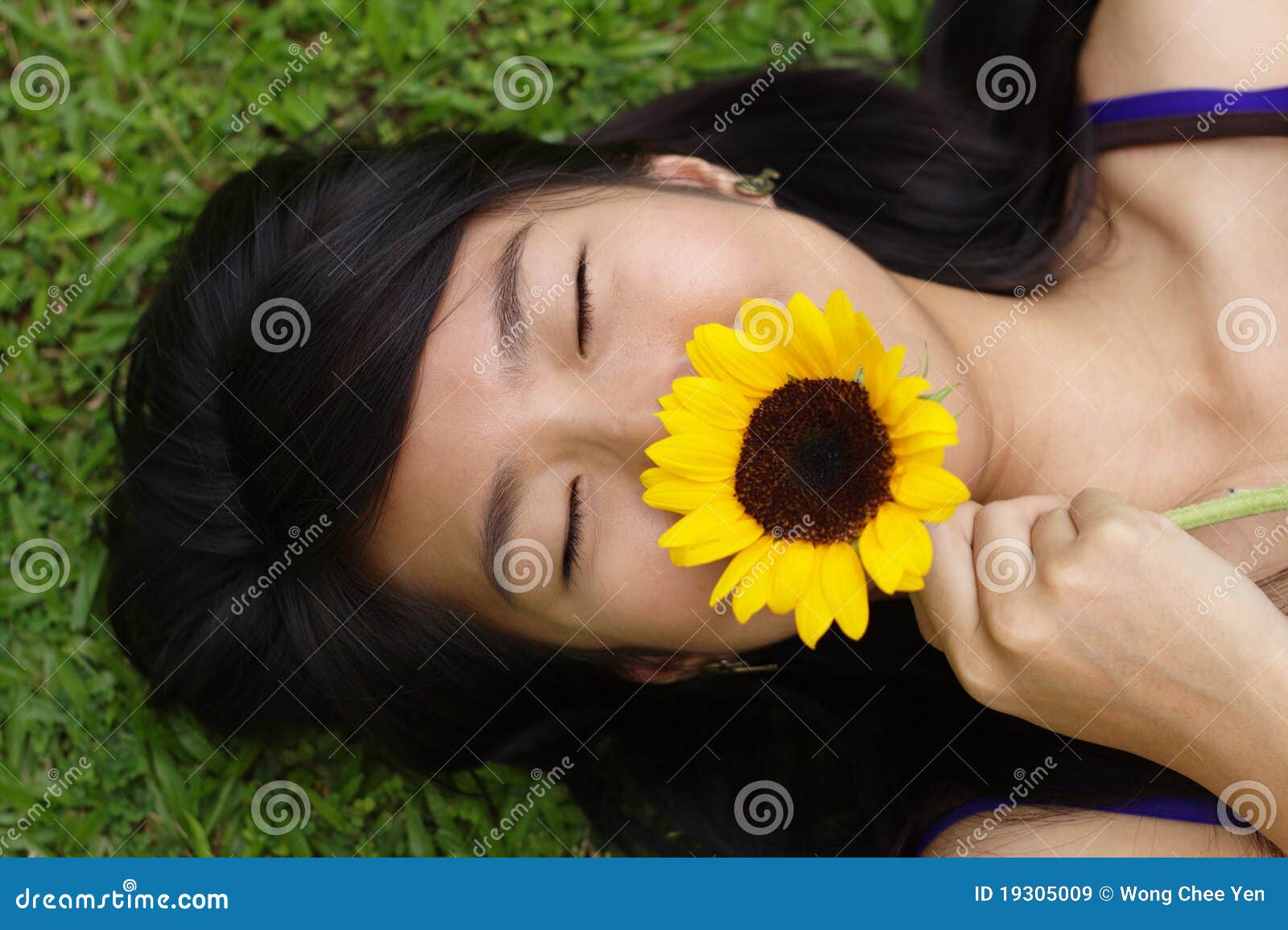 Asian lady smelling flower stock image. Image of closeup - 19305009