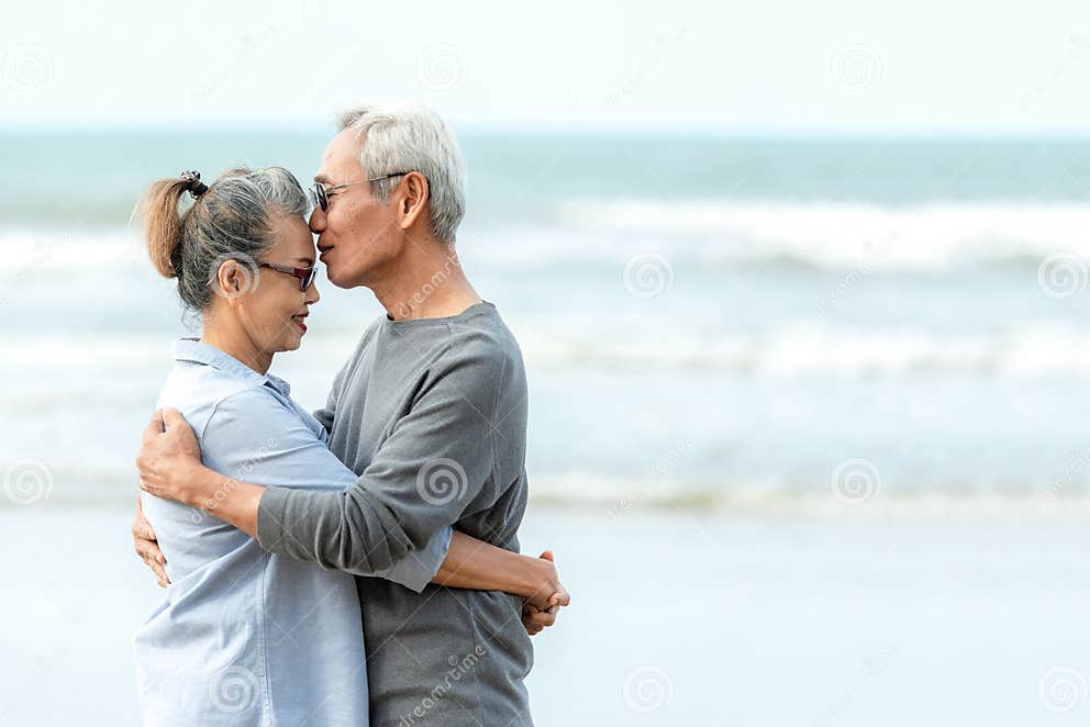 Asian Lifestyle Senior Couple Hug And Kiss On The Beach Happy In Love