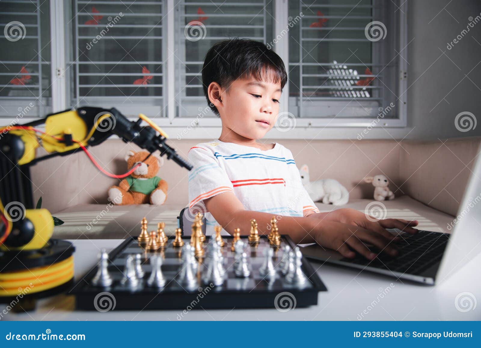 Asian Little Boy Programming Code To Robot Machine Arm on Laptop for ...