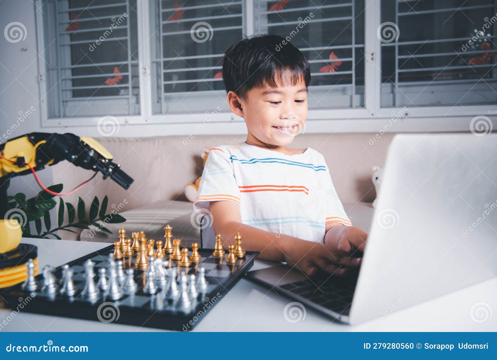 Asian Little Boy Programming Code To Robot Machine Arm on Laptop for ...
